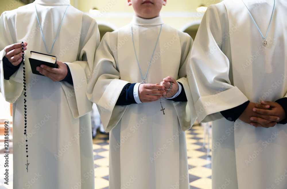 First Holy Communion concept - close up on rosary on child's hands Her ...