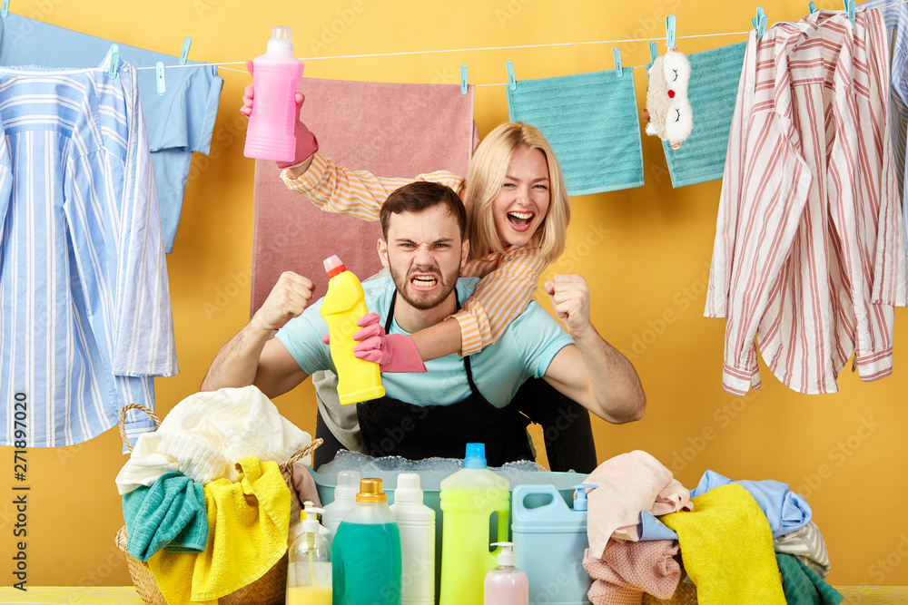 mad funny woman sitting on her boufriend's back holding bottle of ...