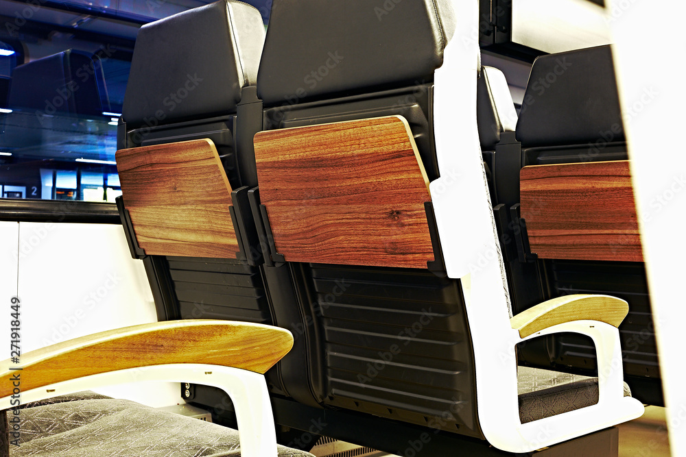 Train seats in a train compartment in white optic with wood at a train ...