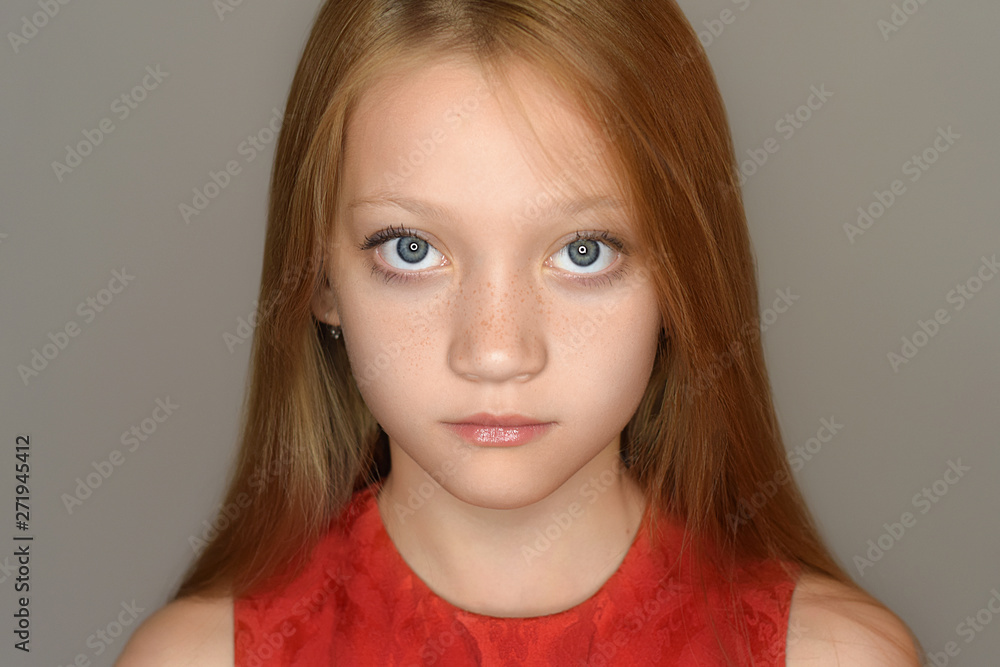 portrait of a red-haired teen girl with beautiful big eyes who looks ...