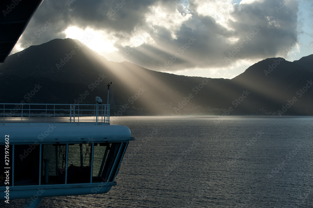 View of a cruise ships control deck as it approaches mountains with sun ...