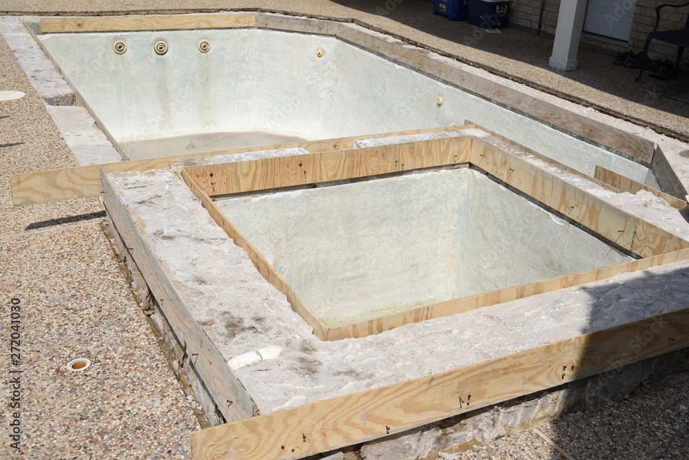 Empty swimming pool under remodel with wooden forms for new tile and ...