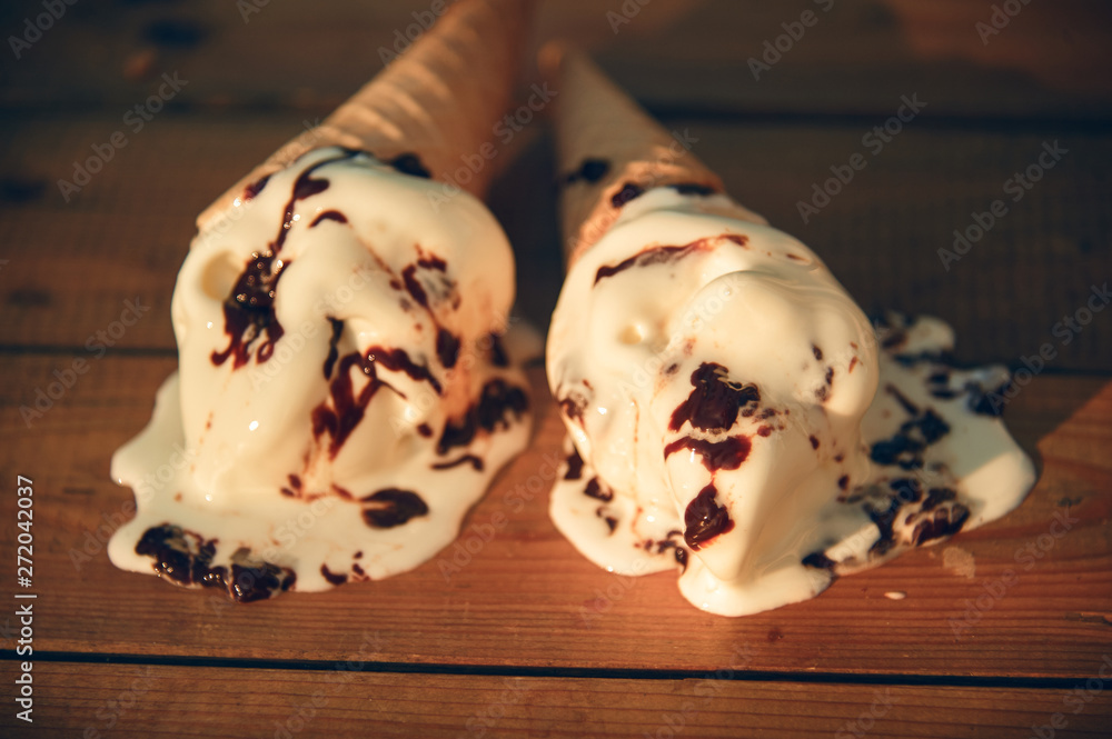 Two horns with gentle ice cream melting in the rays of the summer sun ...