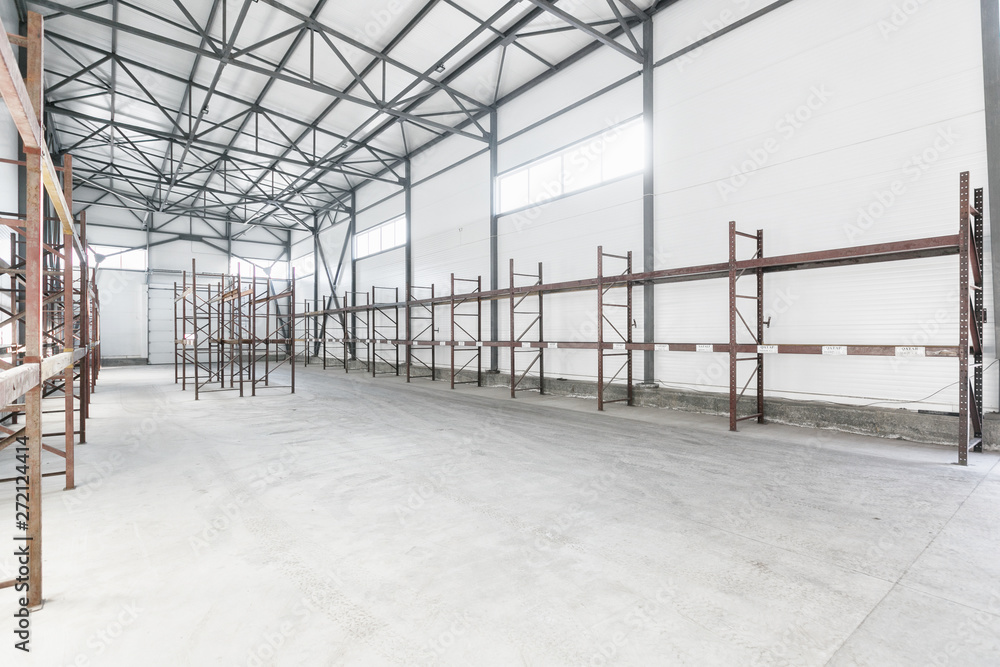 Interior of empty warehouse with empty racks. Stock Photo | Adobe Stock