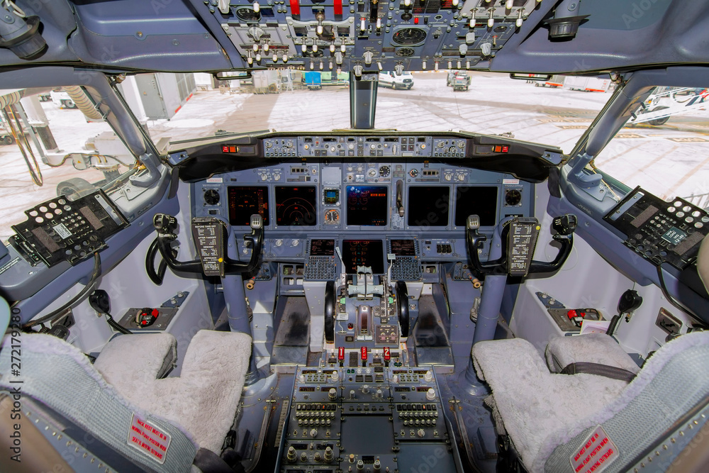 A view of the cockpit of a large commercial airplane a cockpit ...
