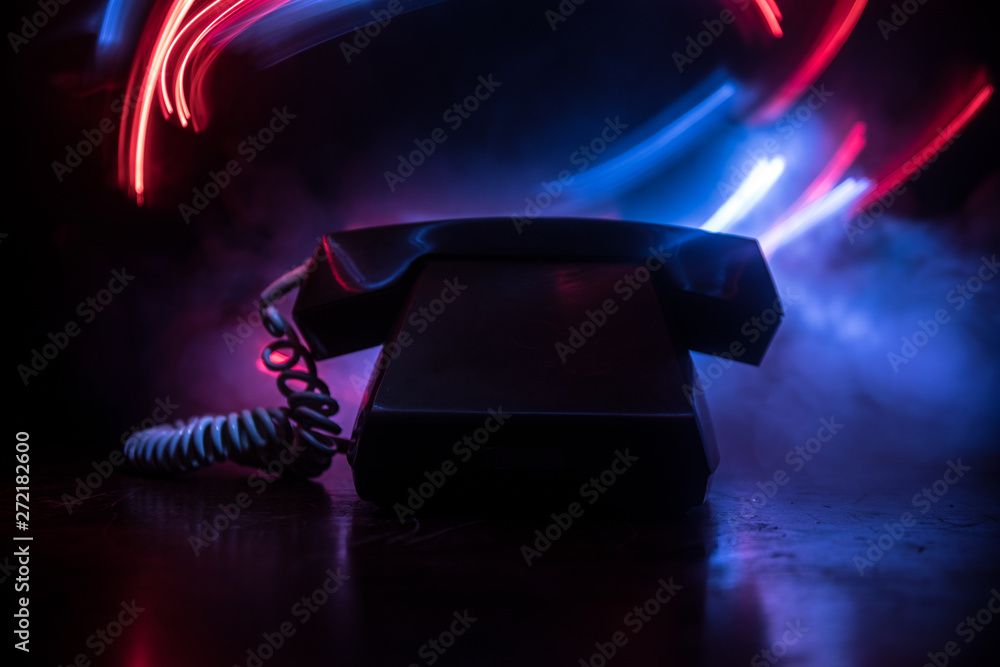 old black telephone on old wood plank with art dark background with fog ...