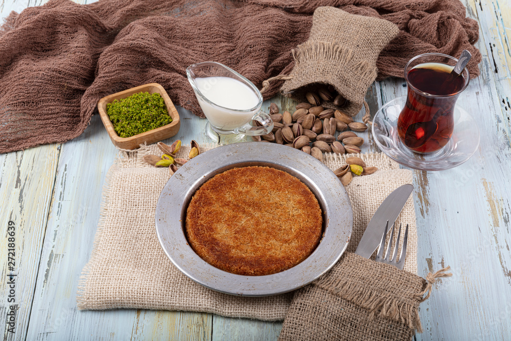 Turkish dessert kunefe, kunafa, kadayif with pistachio powder and ...