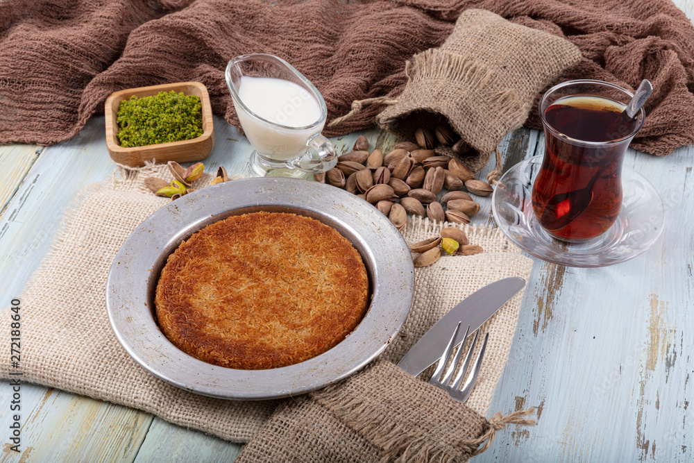 Turkish dessert kunefe, kunafa, kadayif with pistachio powder and ...