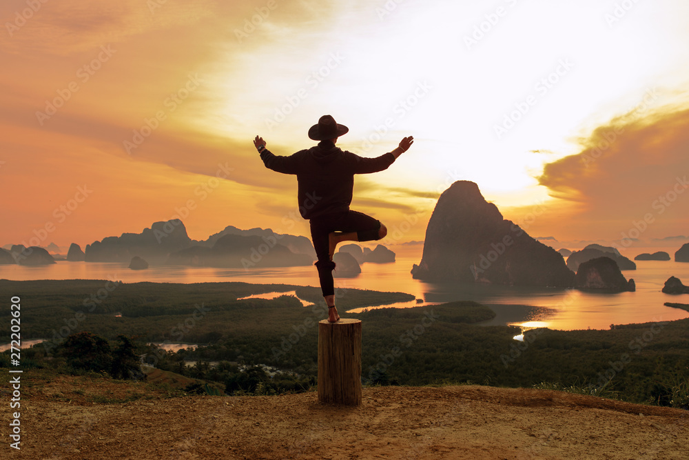 Back view of a Yoga pose. Happy man in black clothes doing yoga pose ...