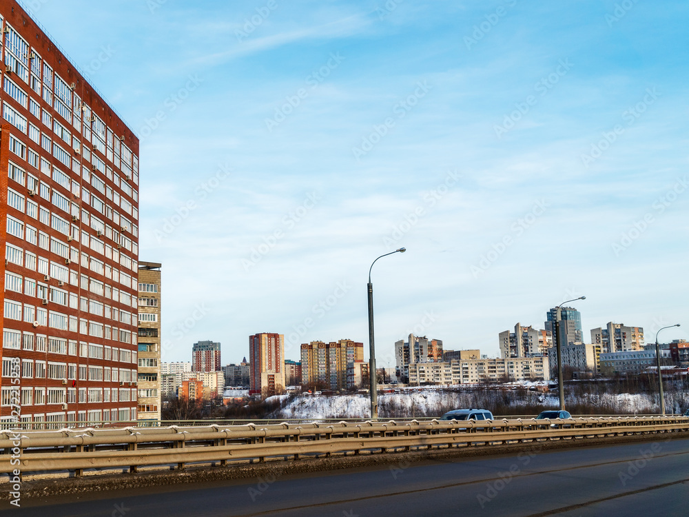 City of Perm. On the left, close-up is a red brick house. In the depth ...