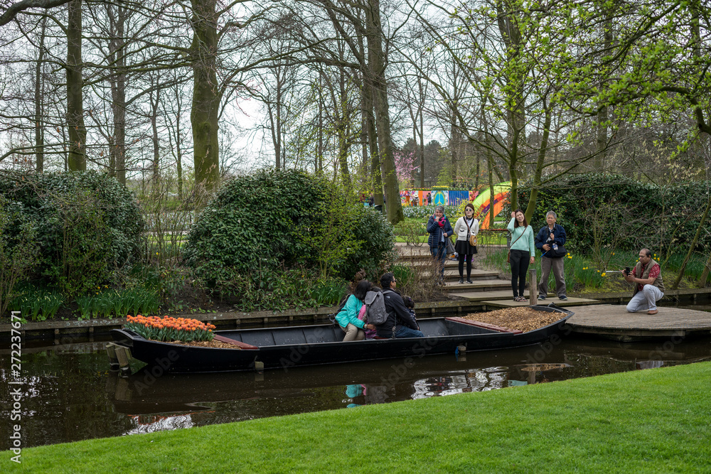 Flower garden, Netherlands , a group of people in a boat on a river ...