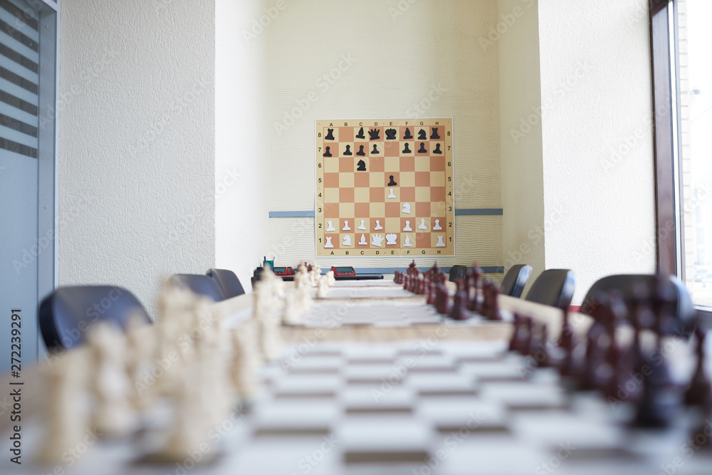 Chess classroom at school with chess poster on wall and long table with ...