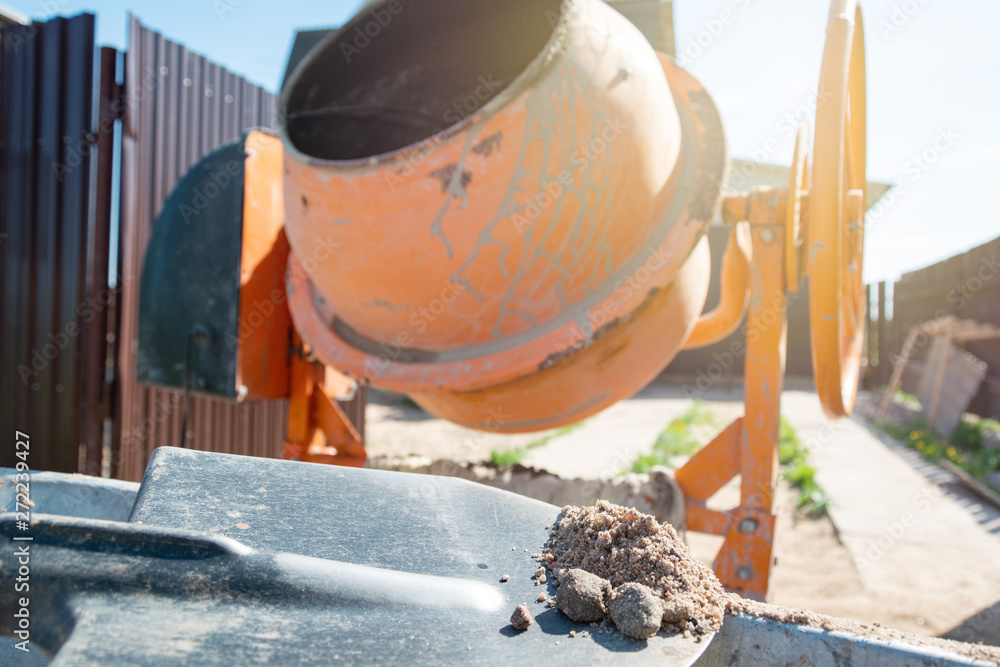 builder working with shovel during concrete cement solution mortar ...