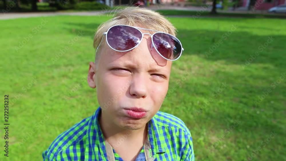 Closeup portrait of cute funny little white kid posing before camera ...
