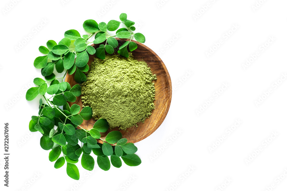 Moringa powder (Moringa Oleifera) in wooden bowl with original fresh ...