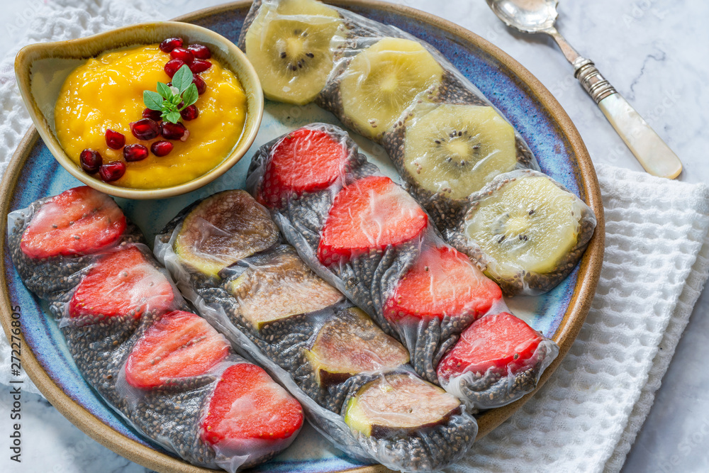 Chia seeds and fruit rice paper rolls with mango dipping sauce Stock ...