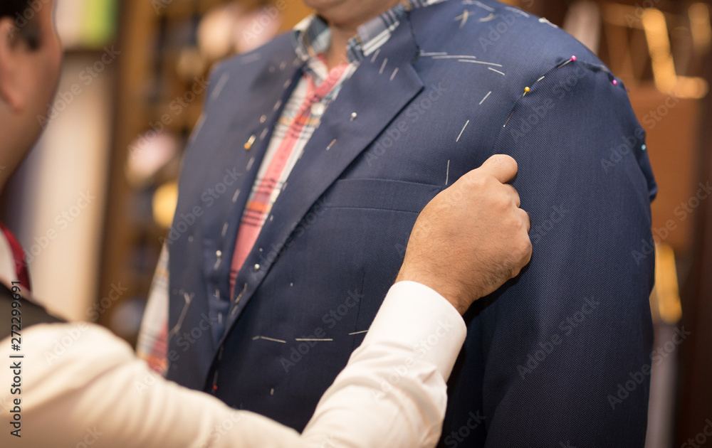 Tailor working with custom made suit Stock Photo | Adobe Stock