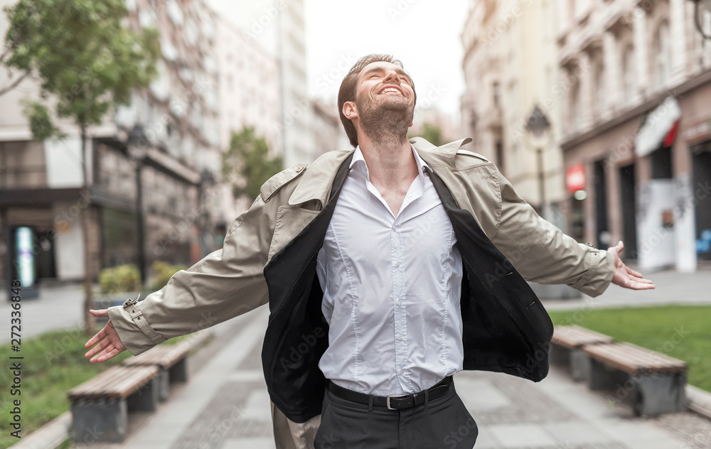 Young thankful man walking the urban streets of his city, appreciating ...