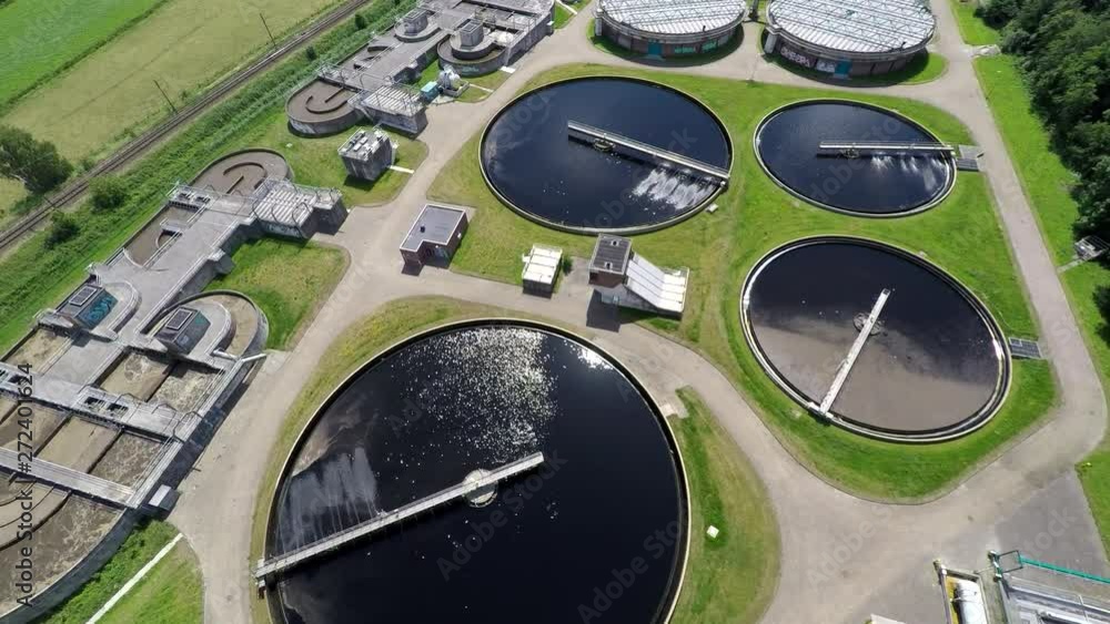 Aerial shot of water basins at sewage treatment plant. A sewage ...