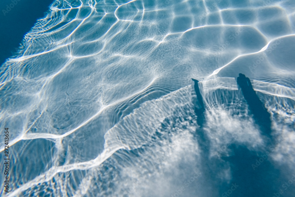 Underwater view of abstract swimmers shadow clean suburban swimming ...