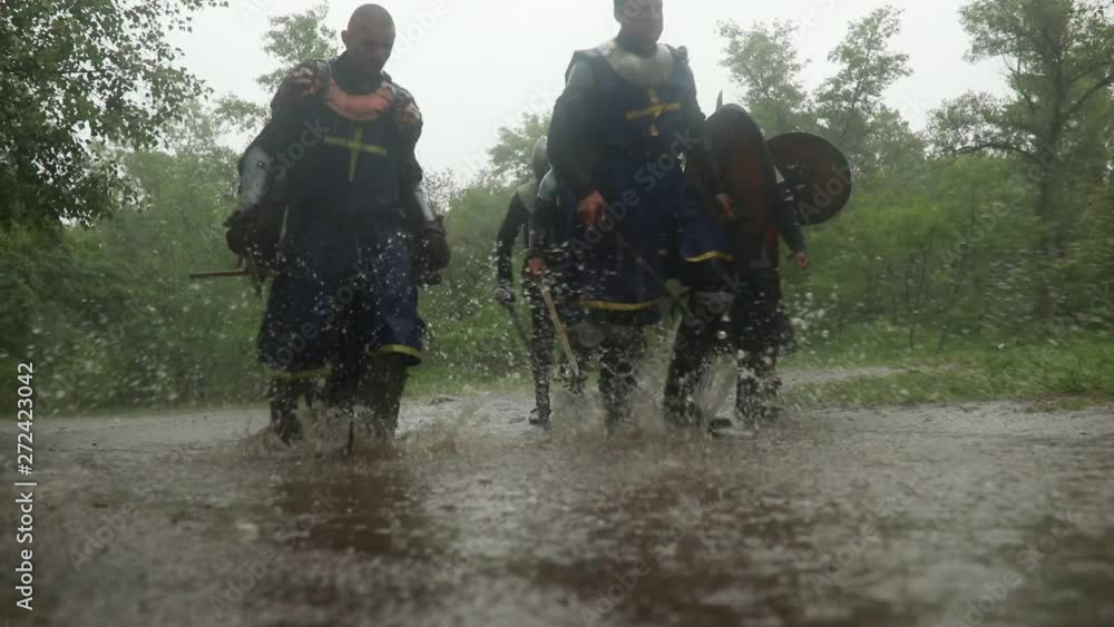 Battle squad of medieval knights of the Crusaders goes in armor and ...