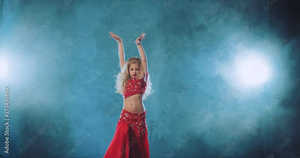 Beautiful girl blonde with long hair dancing belly dance in tubers of ...