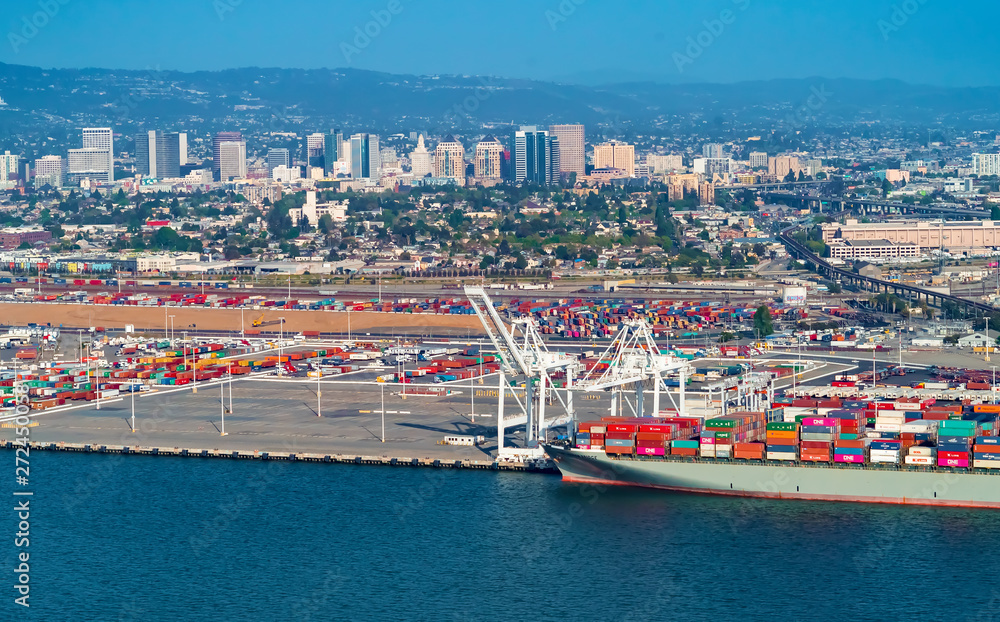 Oakland Harbor port terminal with cargo ship and shipping containers ...