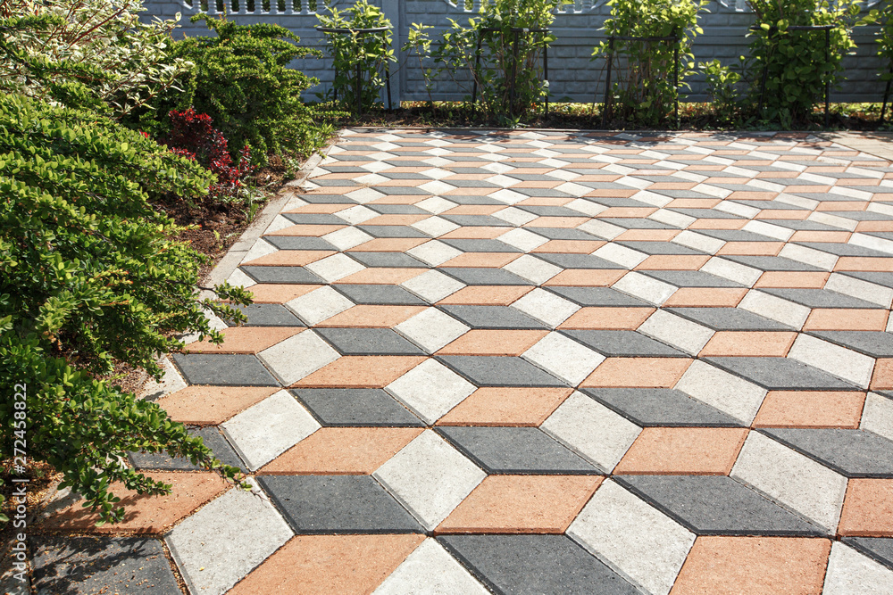 Poster Paving the yard with colored paving tiles in the shape of a ...