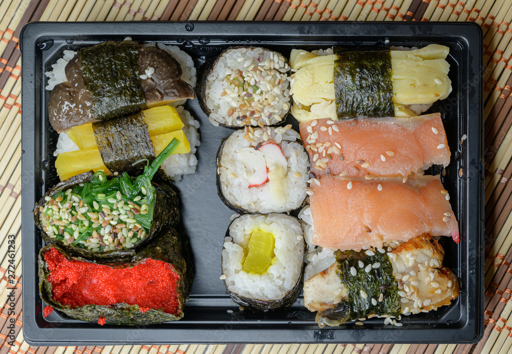 Set of various rolls in black plastic box. Rolles collection with crab ...