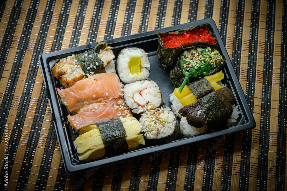 Set of various rolls in black plastic box. Rolles collection with crab ...