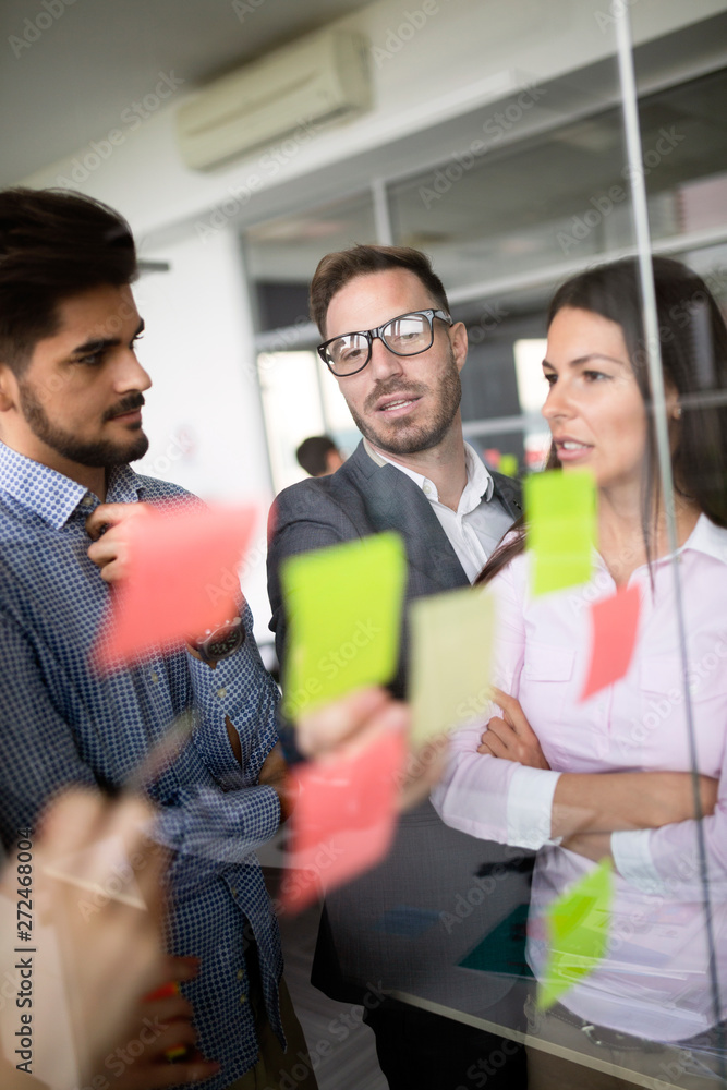 Business people meeting at office and use post it notes to share idea ...