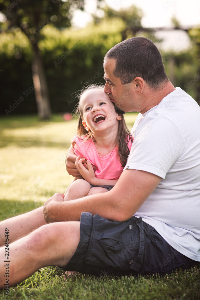 Father hugging and kissing her happy, laughing child Stock Photo ...