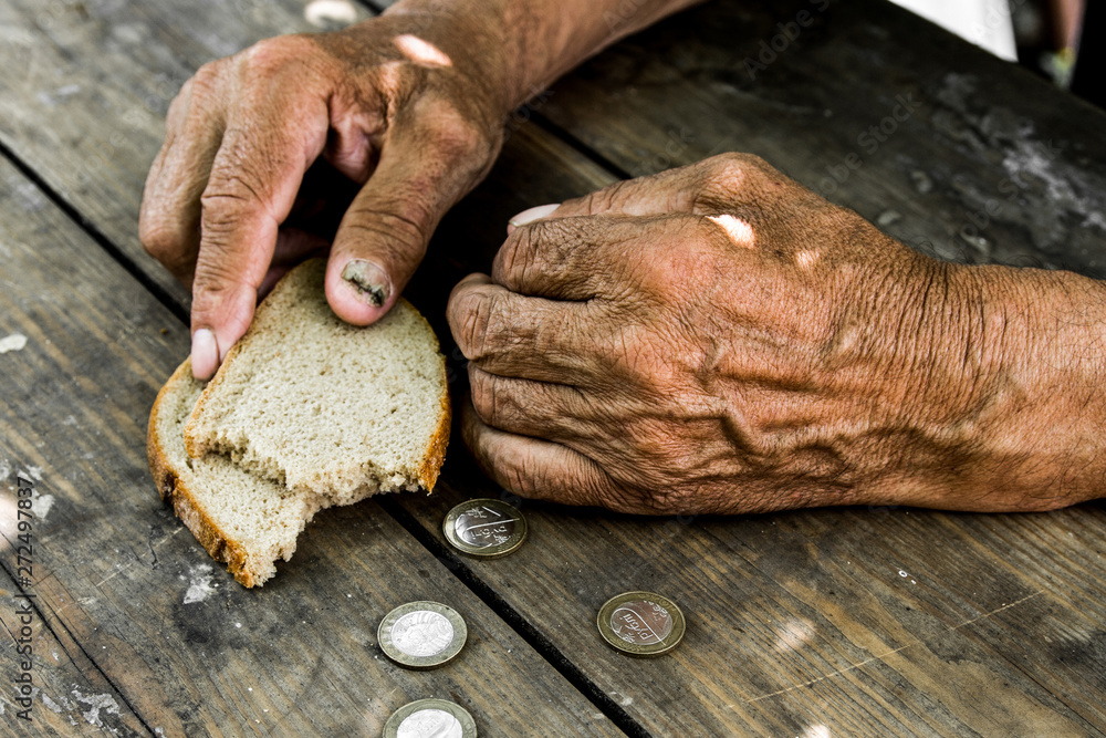 Hands the poor old man's, piece of bread and change, pennies on wood ...