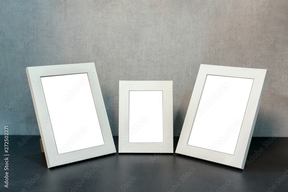 Three photo frames on the wooden shelf in the living room at home, the ...