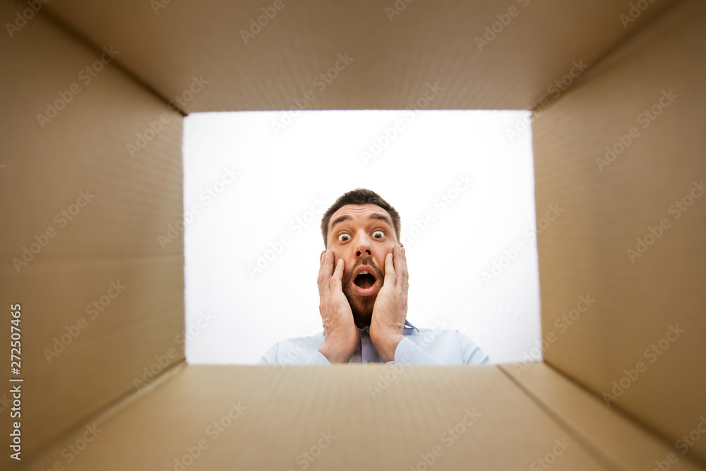 emotions, delivery and surprise concept - shocked man looking into open ...