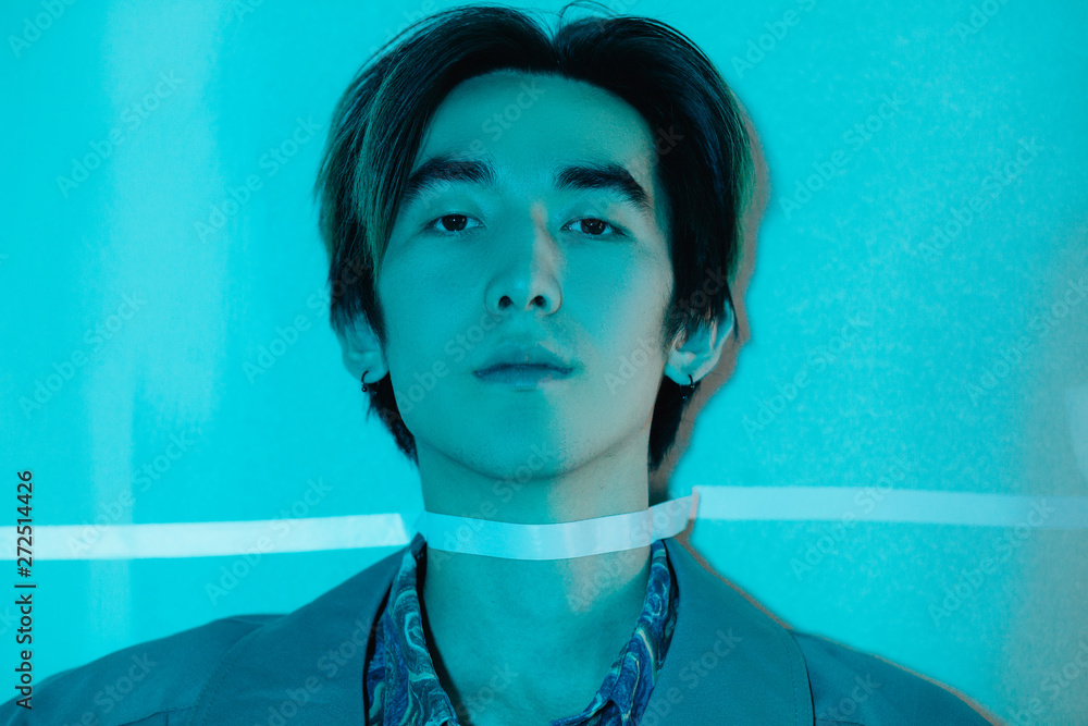 Asian man taped to wall Stock Photo | Adobe Stock