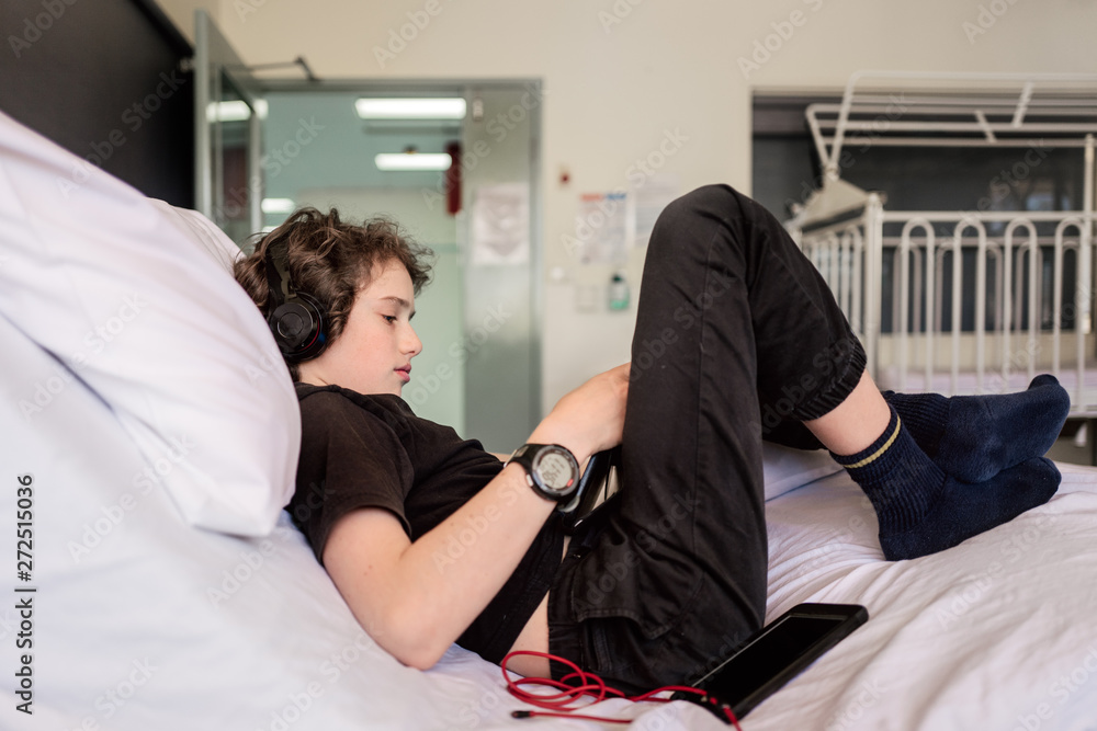 Boy on a hospital bed in a hospital room with digital devices Stock ...