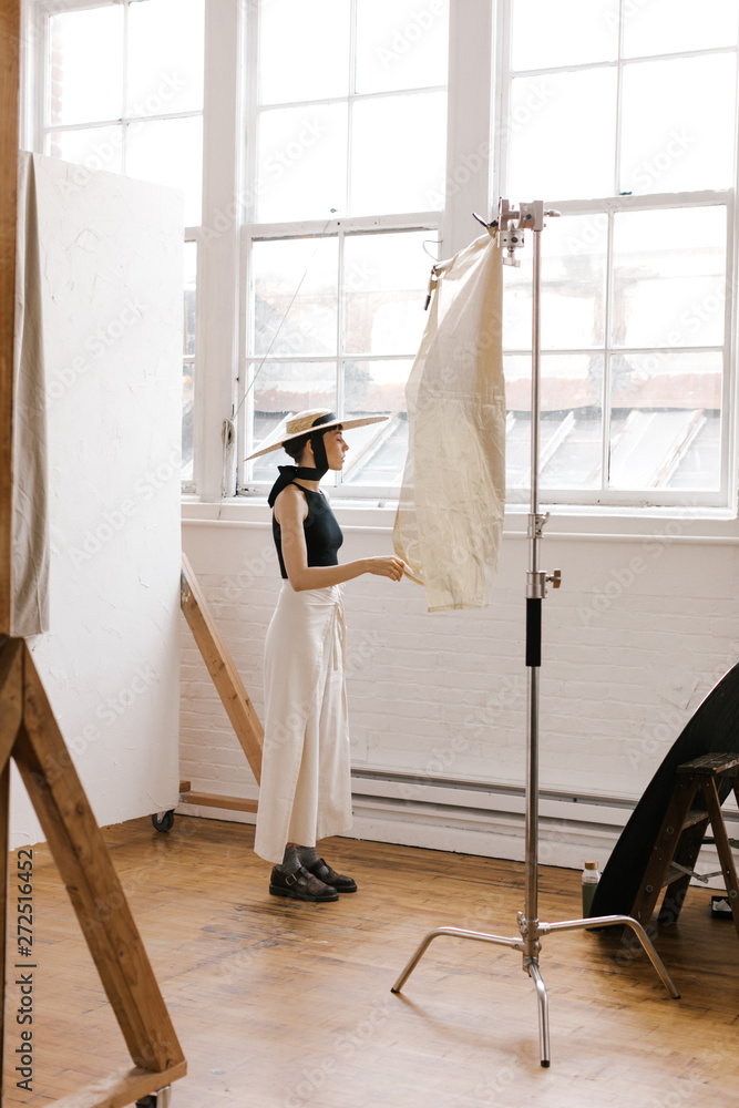 behind the scenes of model in photo studio with backdrop walls and c ...