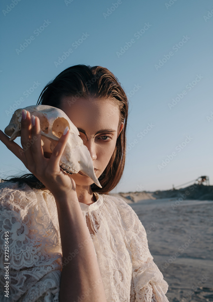 Gorgeous model posing with skull Stock Photo | Adobe Stock