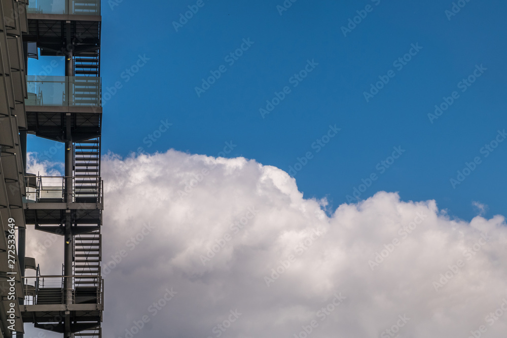 Business building with metal emergency ladder / fire escape in modern ...