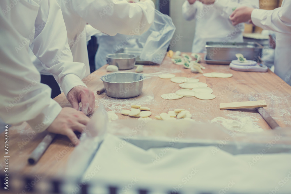 Dim Sum chefs working wrapping dumplings at famous restaurant in Taiwan ...