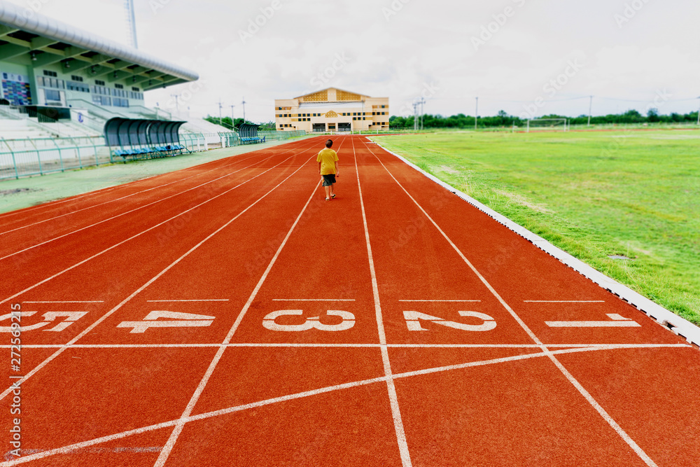 Fat boy walking on Red rubber running track, outdoor sport floor,have ...