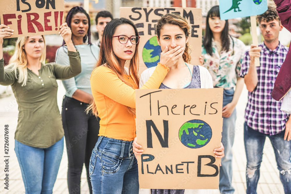 Group of young demonstrators on road, people from different culture and ...