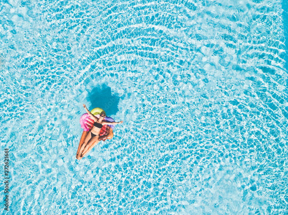 Beautiful young woman lay down enjoying and relaxing on an inflatable ...