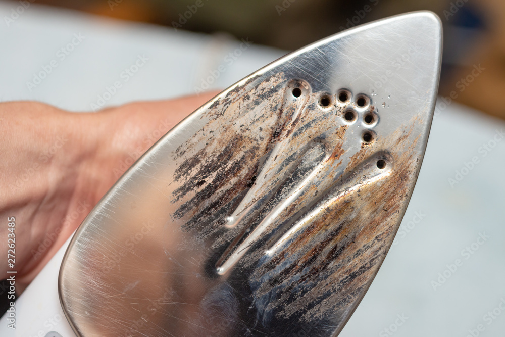 Removal of melted fibers and scrap hardened plastic on the soleplate ...