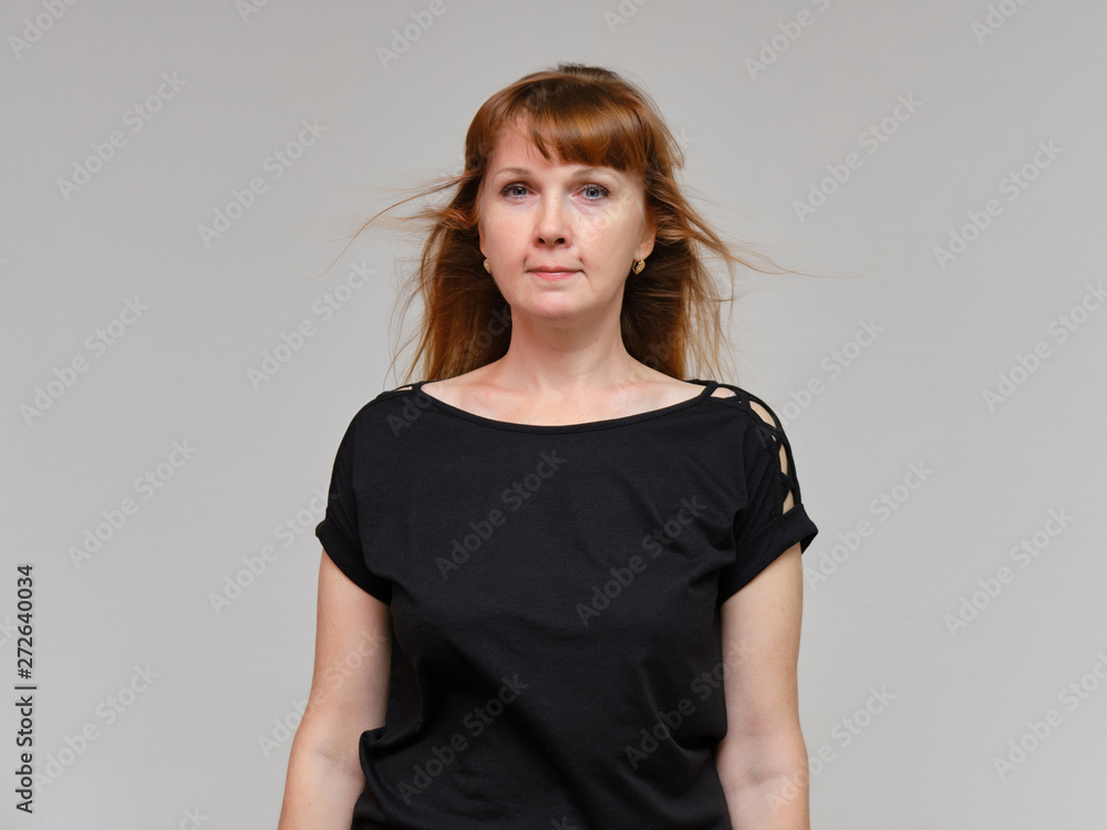 Studio portrait of a beautiful pretty woman aged 40 years on a white ...