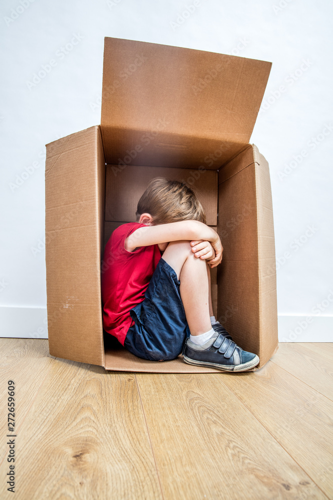 lonely child crying in box, feeling sad, rejected or scared Stock Photo ...