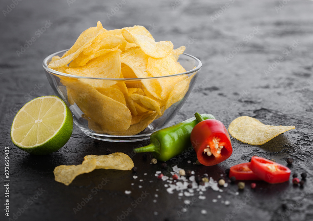 Glass bowl plate with potato crisps chips with onion flavour on black ...