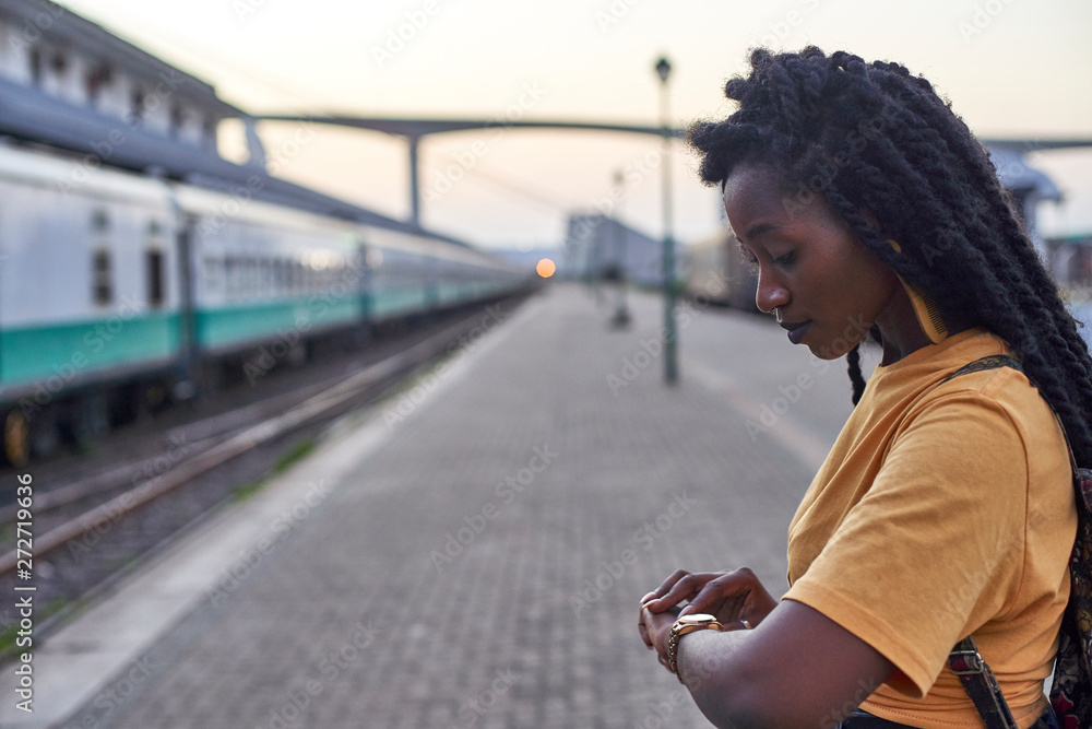 Young woman on platform at the train station checking her watch Stock ...
