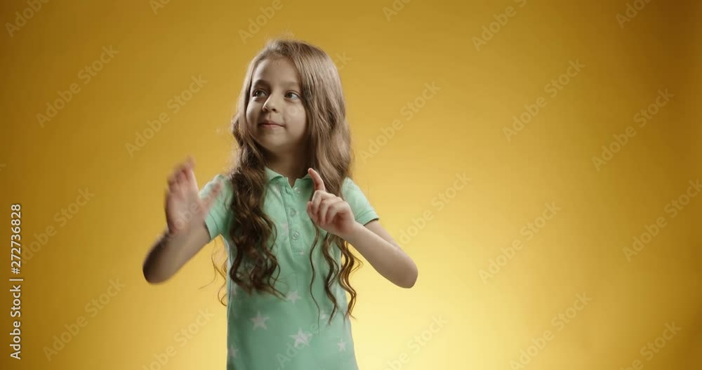 Little caucasian girl points her hands in air, visualising use of ...